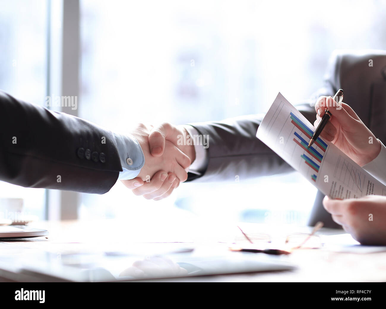 close up.handshake business partners at the office table Stock Photo - Alamy