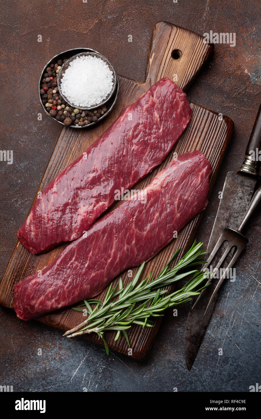 Raw top blade or denver grilled steak on cutting board cooking. Top ...