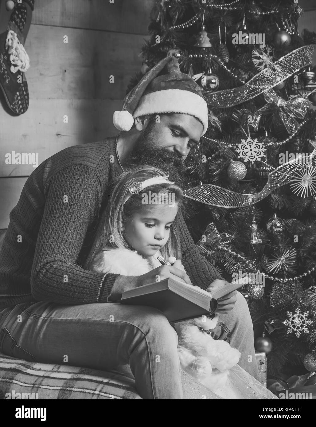 Christmas happy child and father read book Stock Photo - Alamy