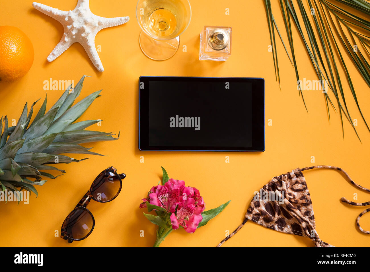 Summer background with a black tablet Stock Photo - Alamy
