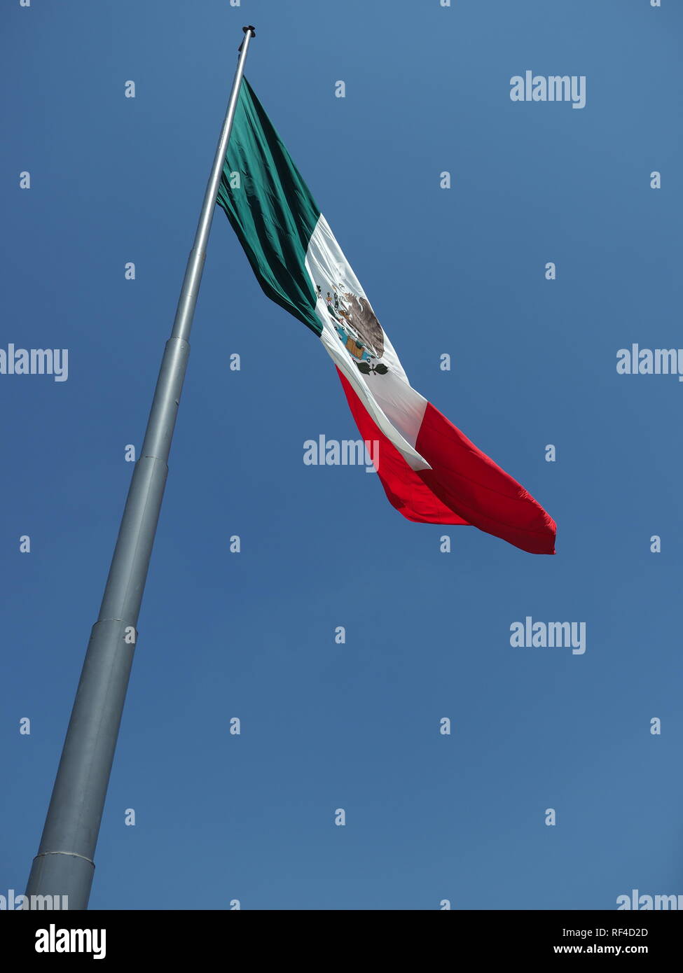 National maxican flag on beach at bay of Pacific Ocean in Acapulco city ...