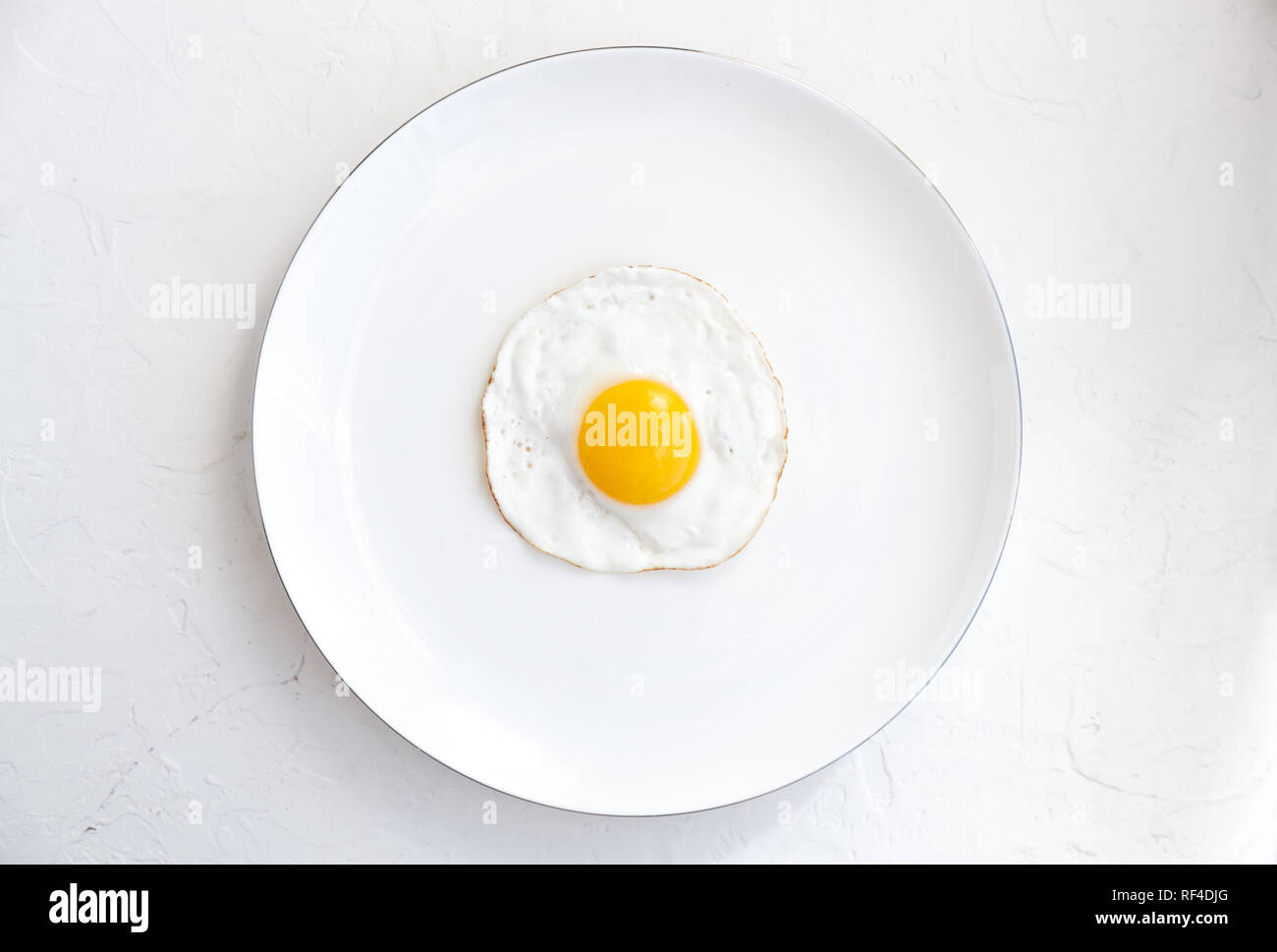 Fried egg isolated on white background, top view Stock Photo - Alamy