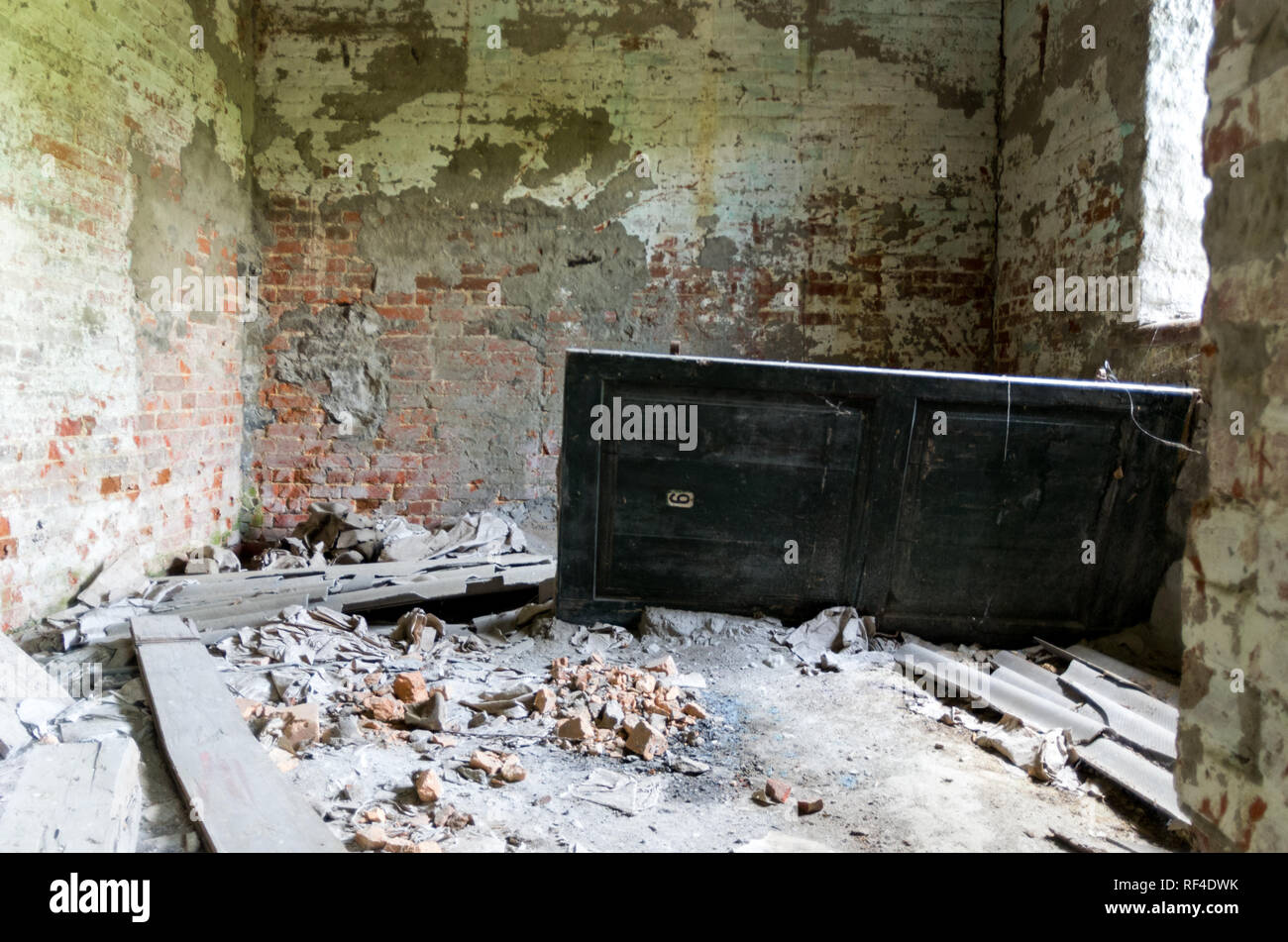A collapsed room. Broken door. Dirt and mess. Brick room Stock Photo ...