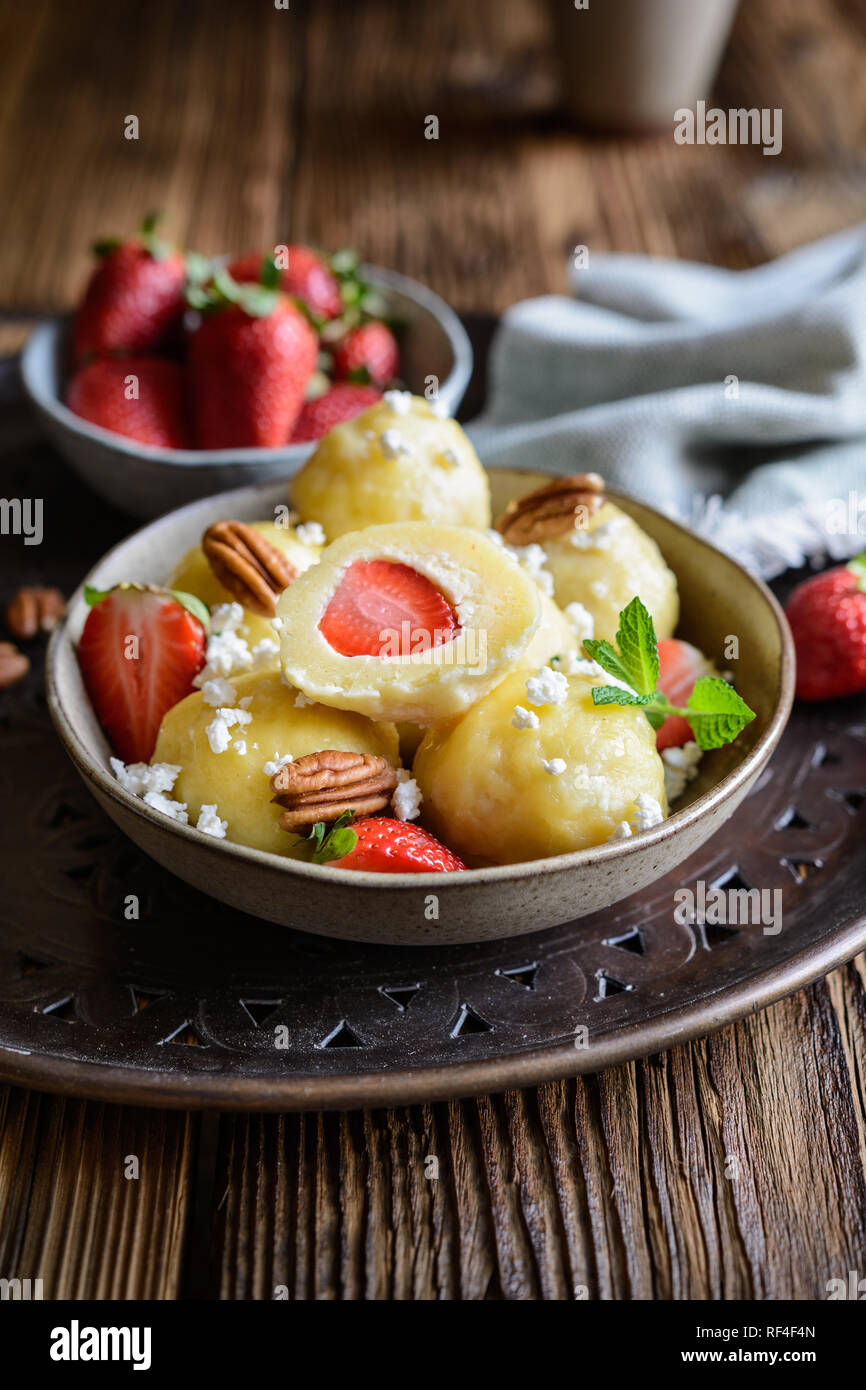 Traditional sweet dumplings stuffed with strawberries topped with curd ...