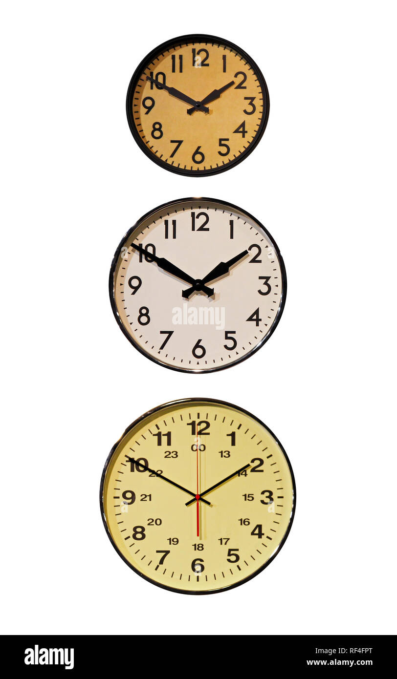 Three clocks in vertical position on wall Stock Photo - Alamy