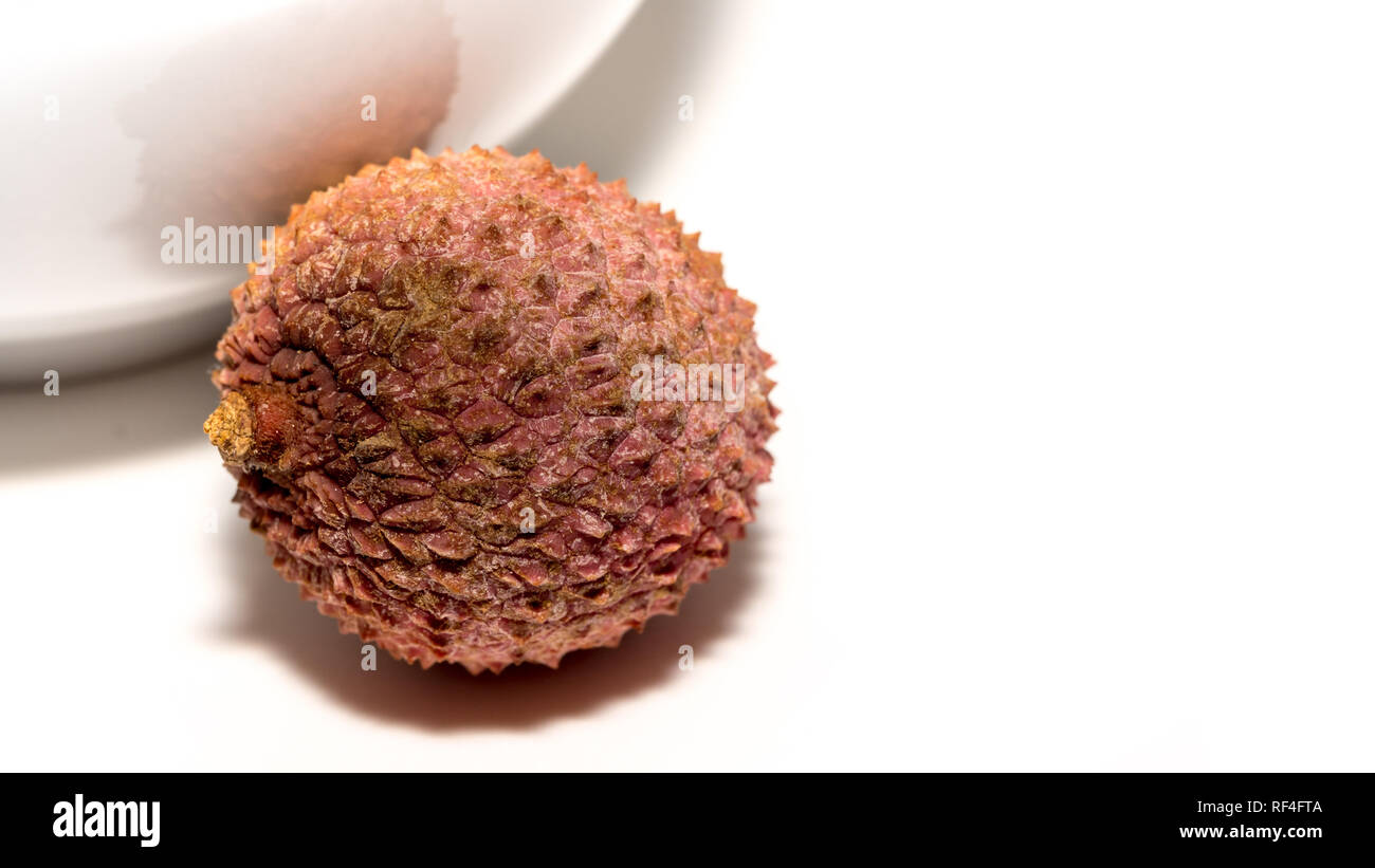 Single lychee fruit, against a white background, detail-taking Stock ...