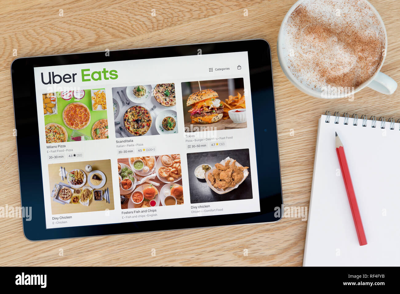 The Uber Eats website features on an iPad tablet device which rests on ...