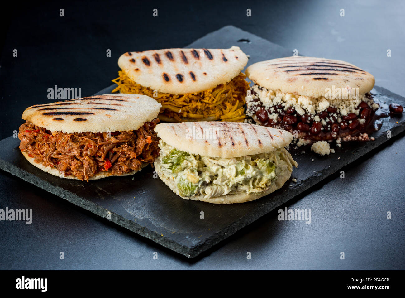 Venezuelan Latin American food, 4 arepas of different stuffing on a ...