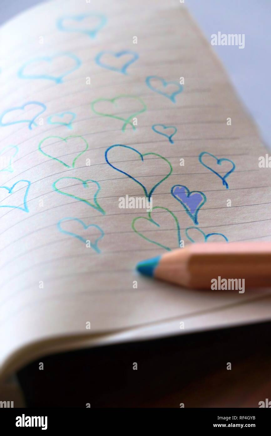 Blue and Green Hearts drawn on lined paper notepad. Colored pencil ...