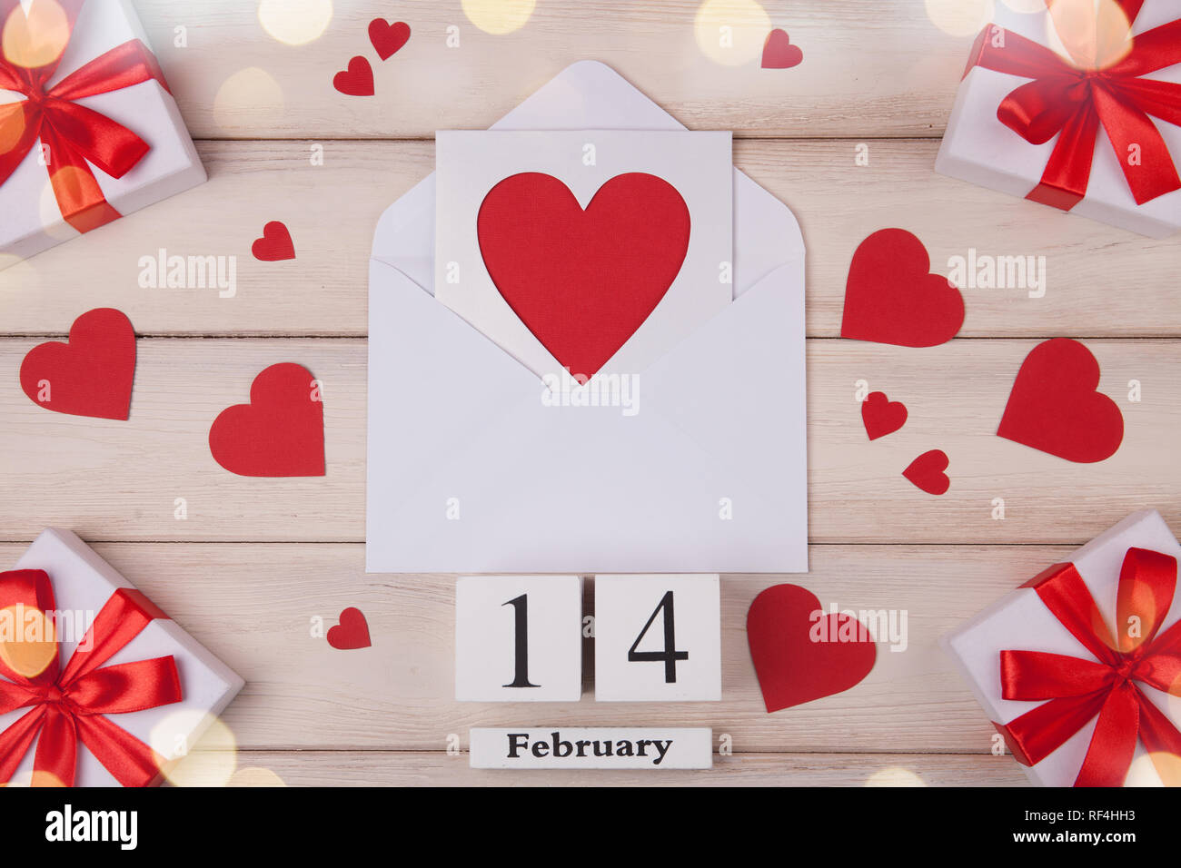 Wooden white background with red hearts, gifts, love envelope and ...
