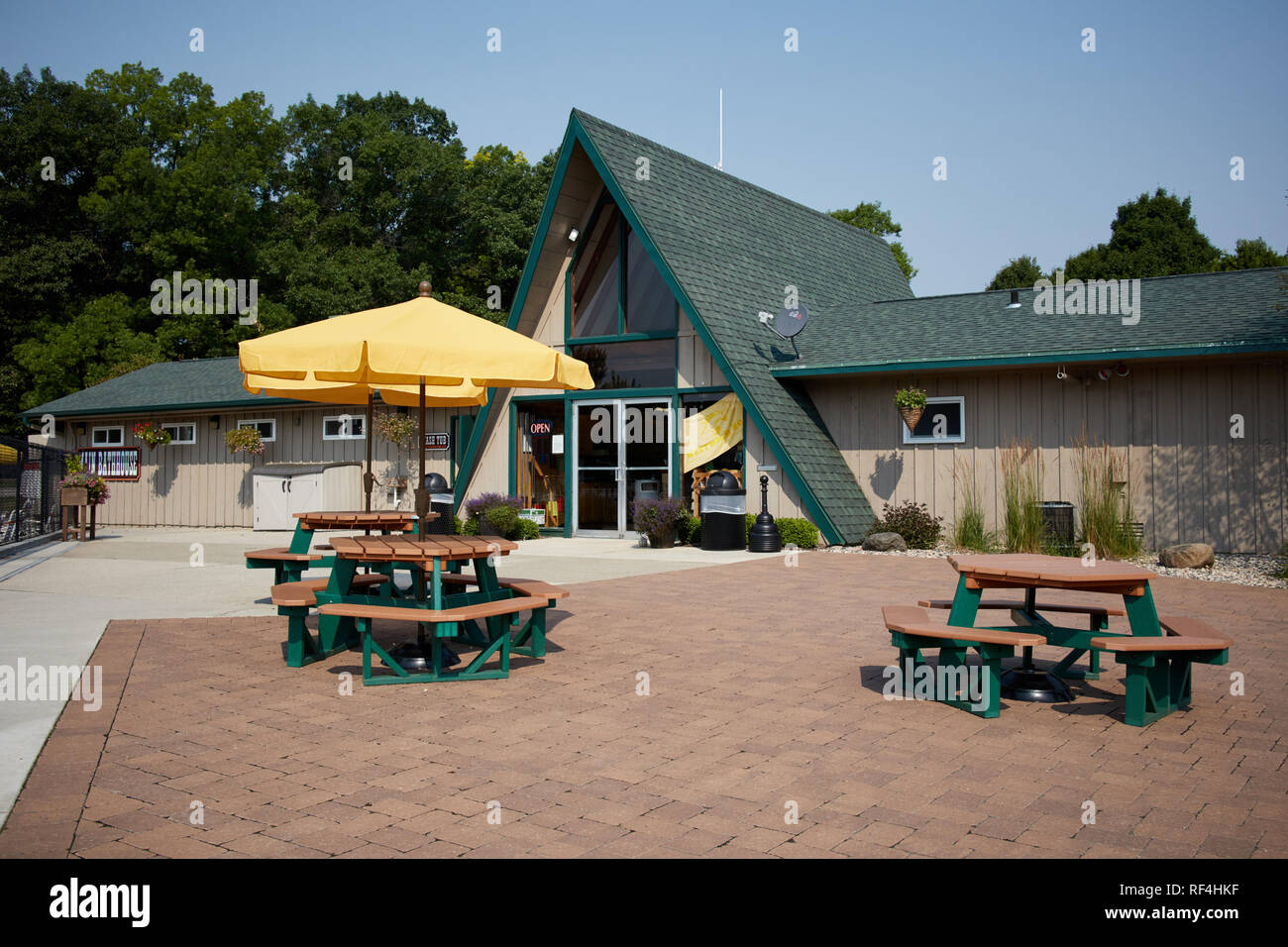 Picnic tables in front of a campground building Stock Photo - Alamy