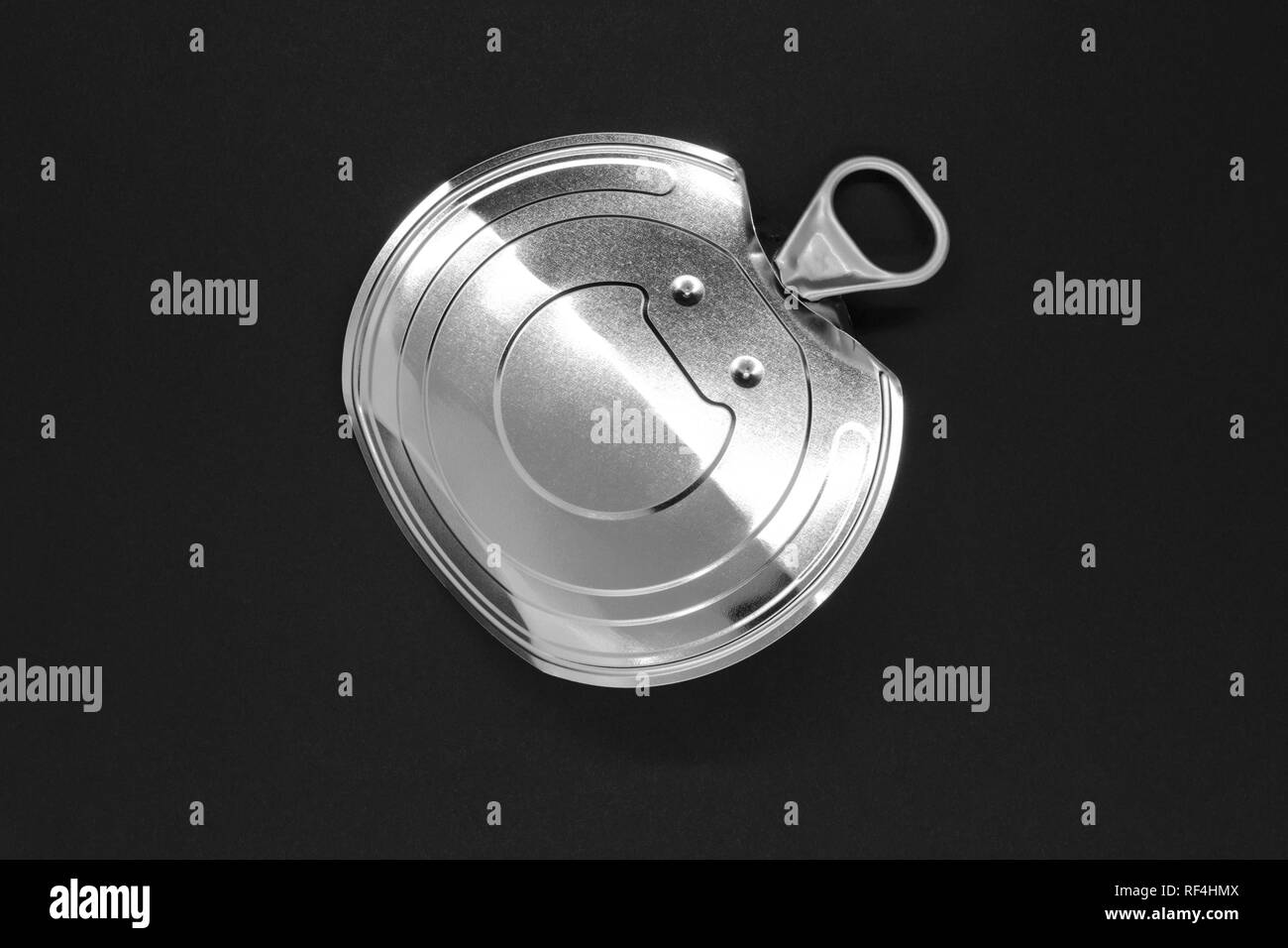 Open and folded silver aluminium can lid on black background Stock ...