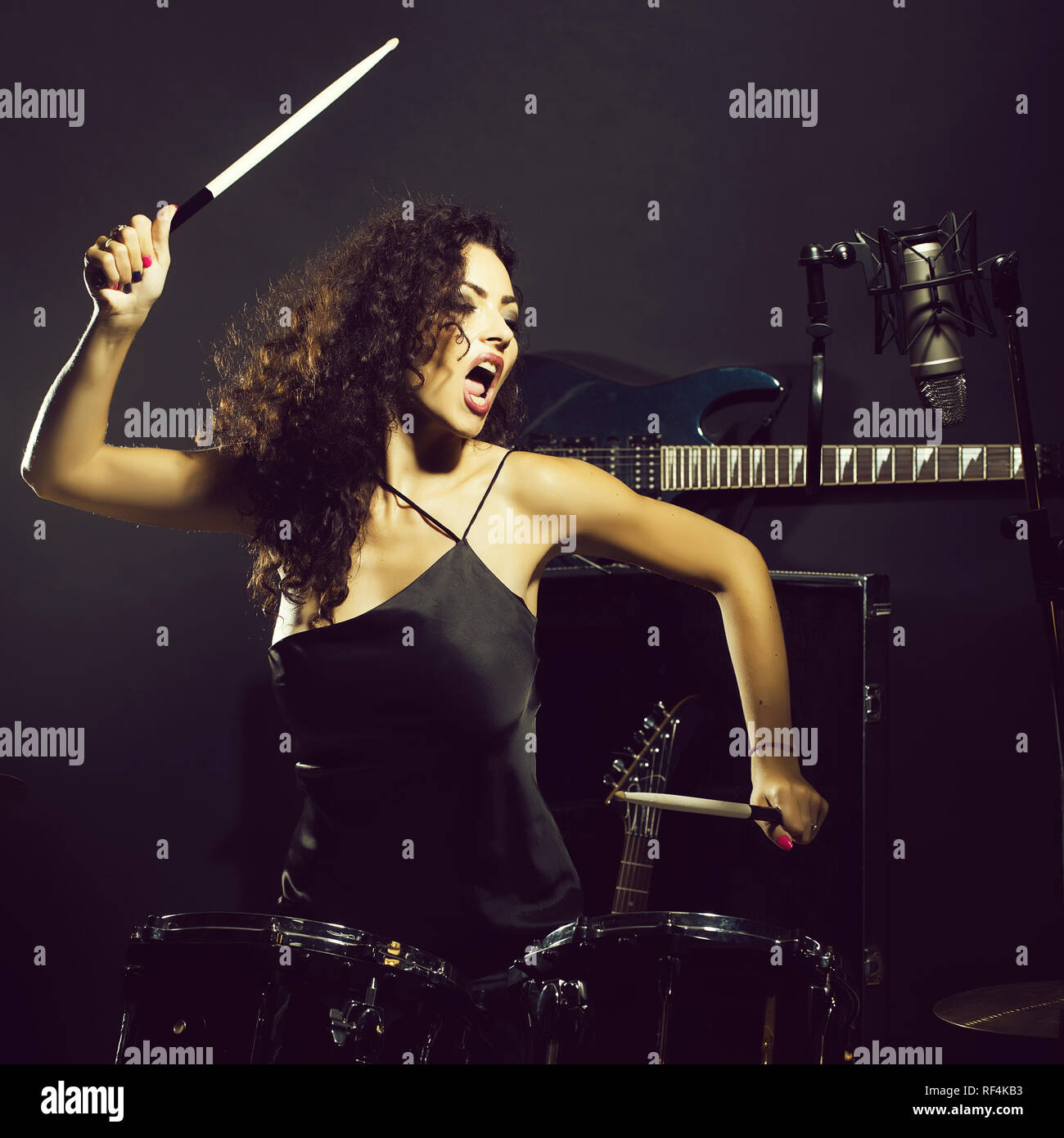 Woman playing drums Stock Photo - Alamy