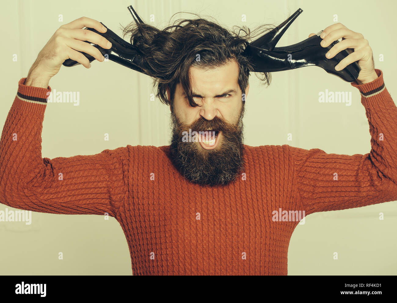angry bearded man with shoes Stock Photo - Alamy