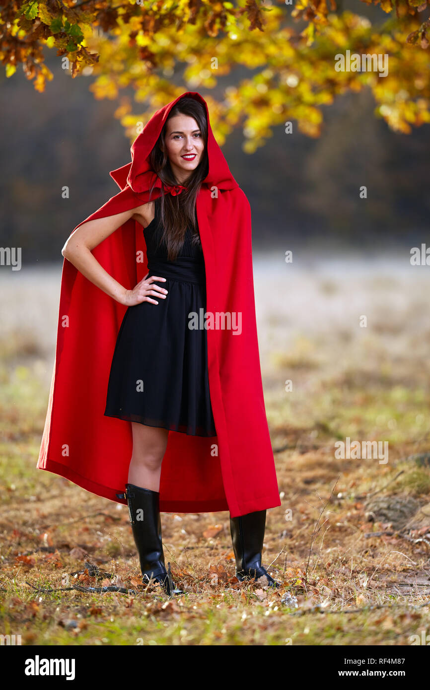 Red riding hood in the forest by an oak tree Stock Photo - Alamy