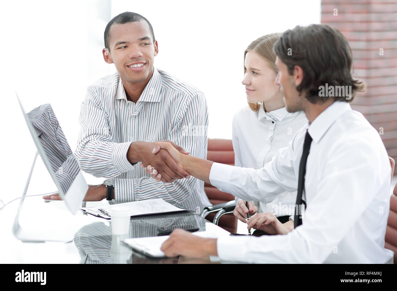 handshake staff at the Desk in the office Stock Photo - Alamy