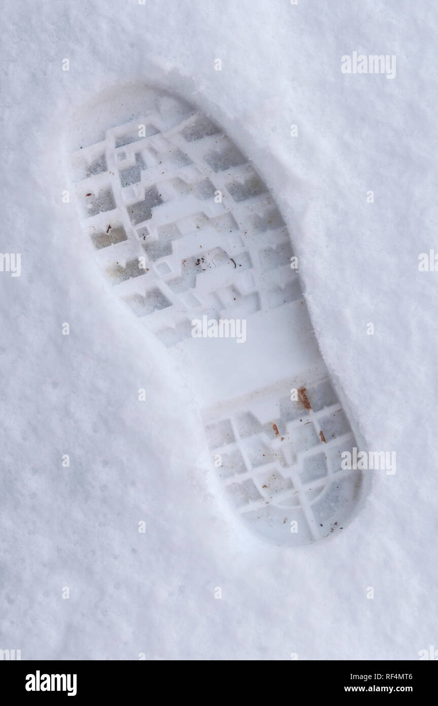 Single boot print in the snow like background walk Stock Photo - Alamy