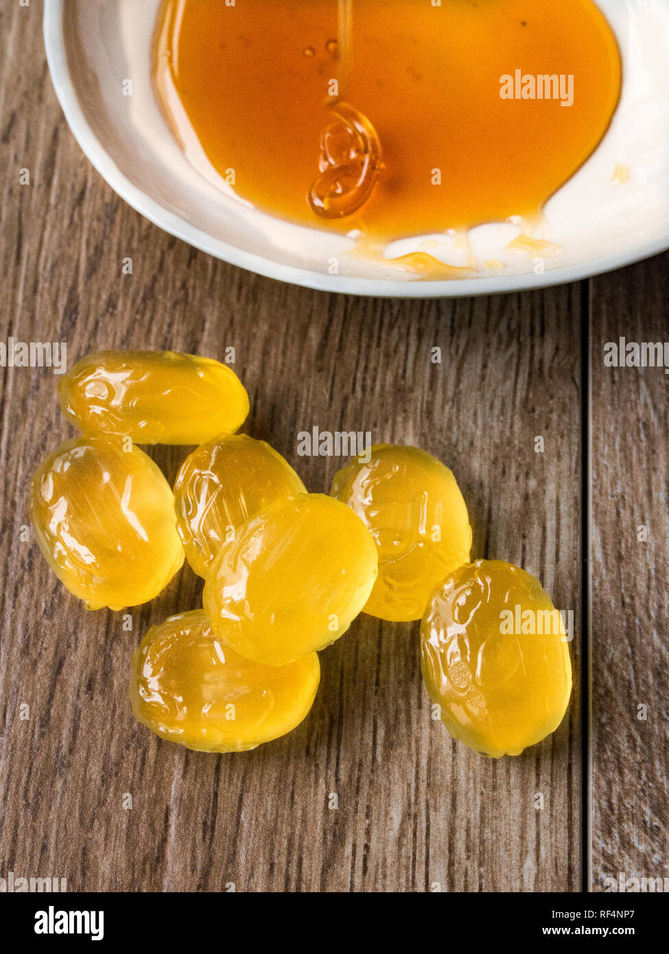 Honey candies on wood background Stock Photo - Alamy