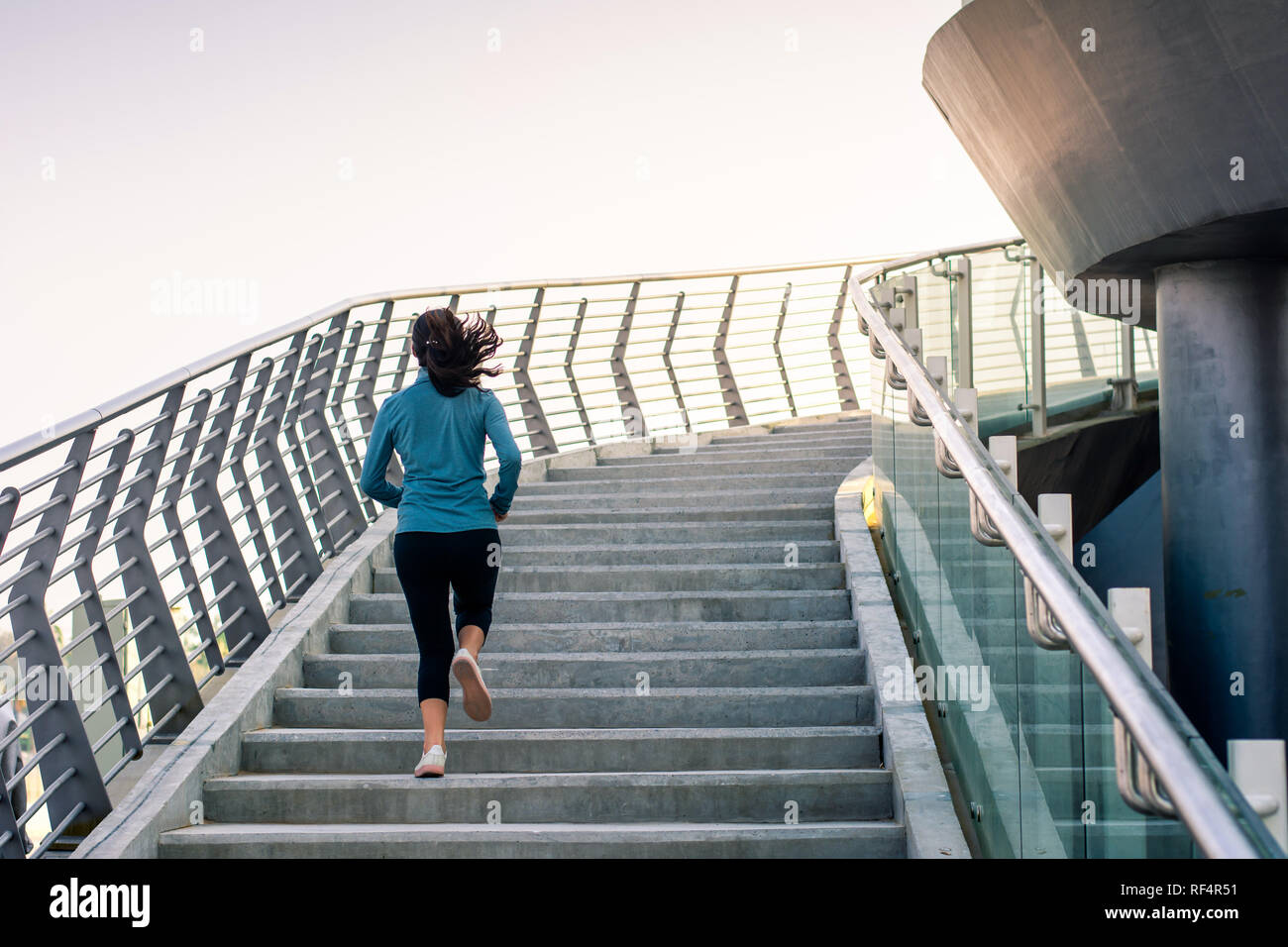 Female running on the stairs during an outdoors workout Stock Photo - Alamy