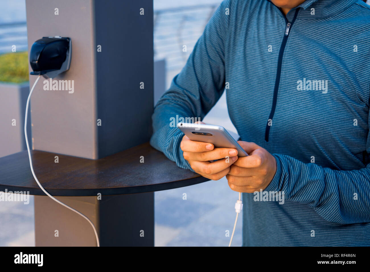 Woman using charging station hi-res stock photography and images - Alamy