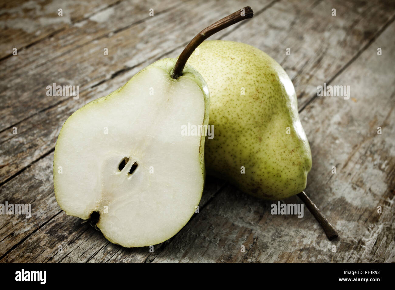 Pear on grungy wooden desk Stock Photo - Alamy