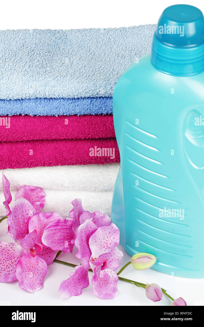 Towels and liquid laundry detergent with orchid flower Stock Photo - Alamy
