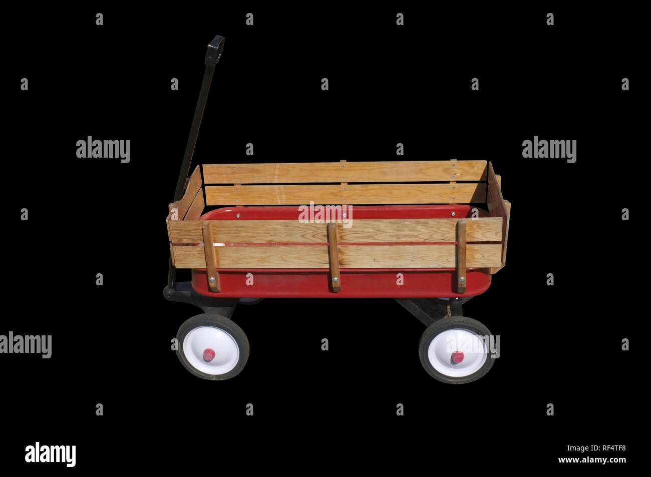 Little red wood wagon on black background Stock Photo - Alamy