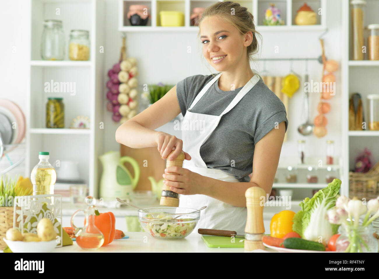 Portrait of girl in the kitchen cook Stock Photo - Alamy