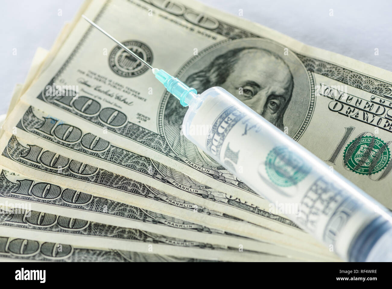close up of syringe with money injection on dollar banknotes Stock ...