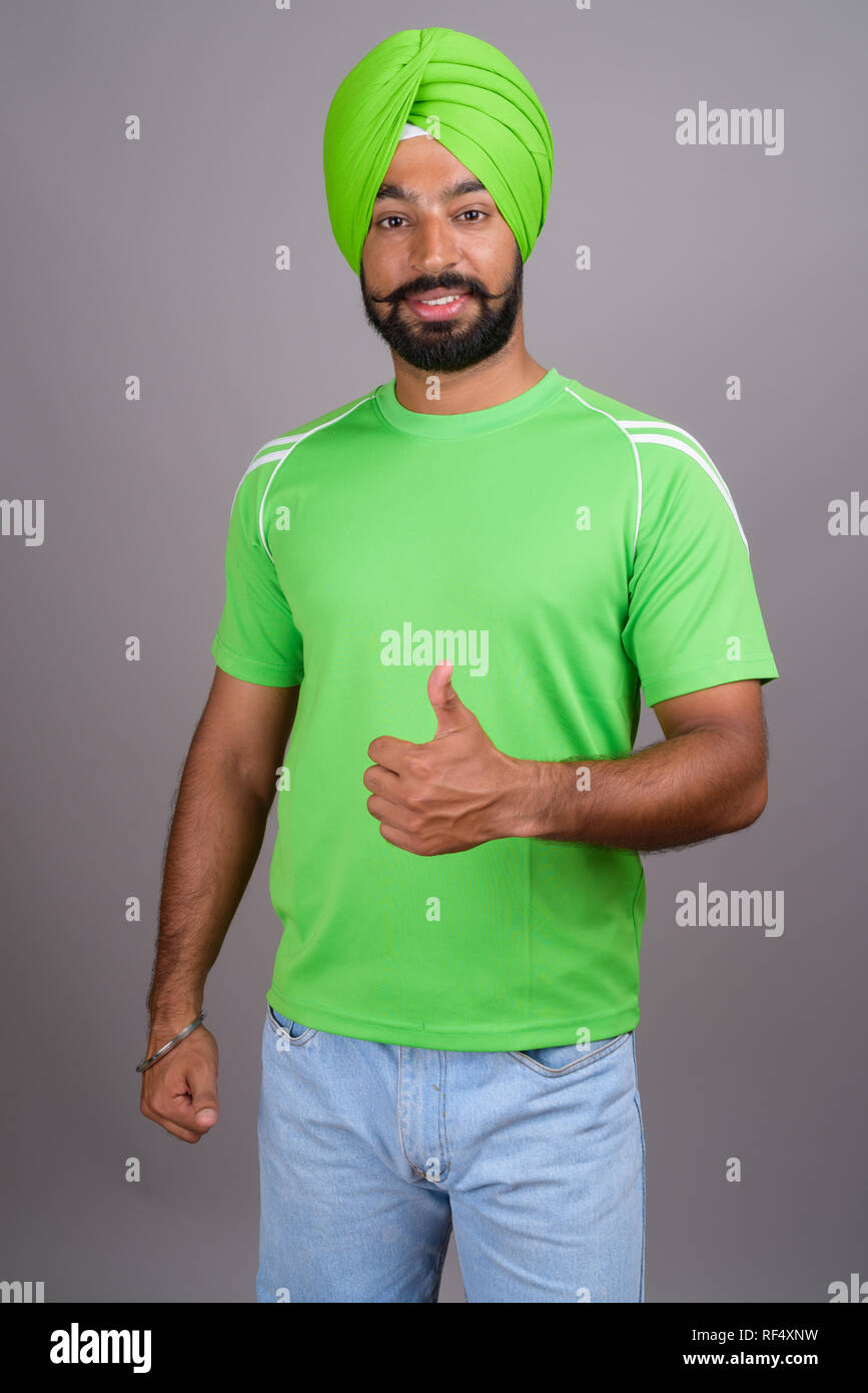 Young handsome Indian Sikh man wearing turban and green shirt Stock ...