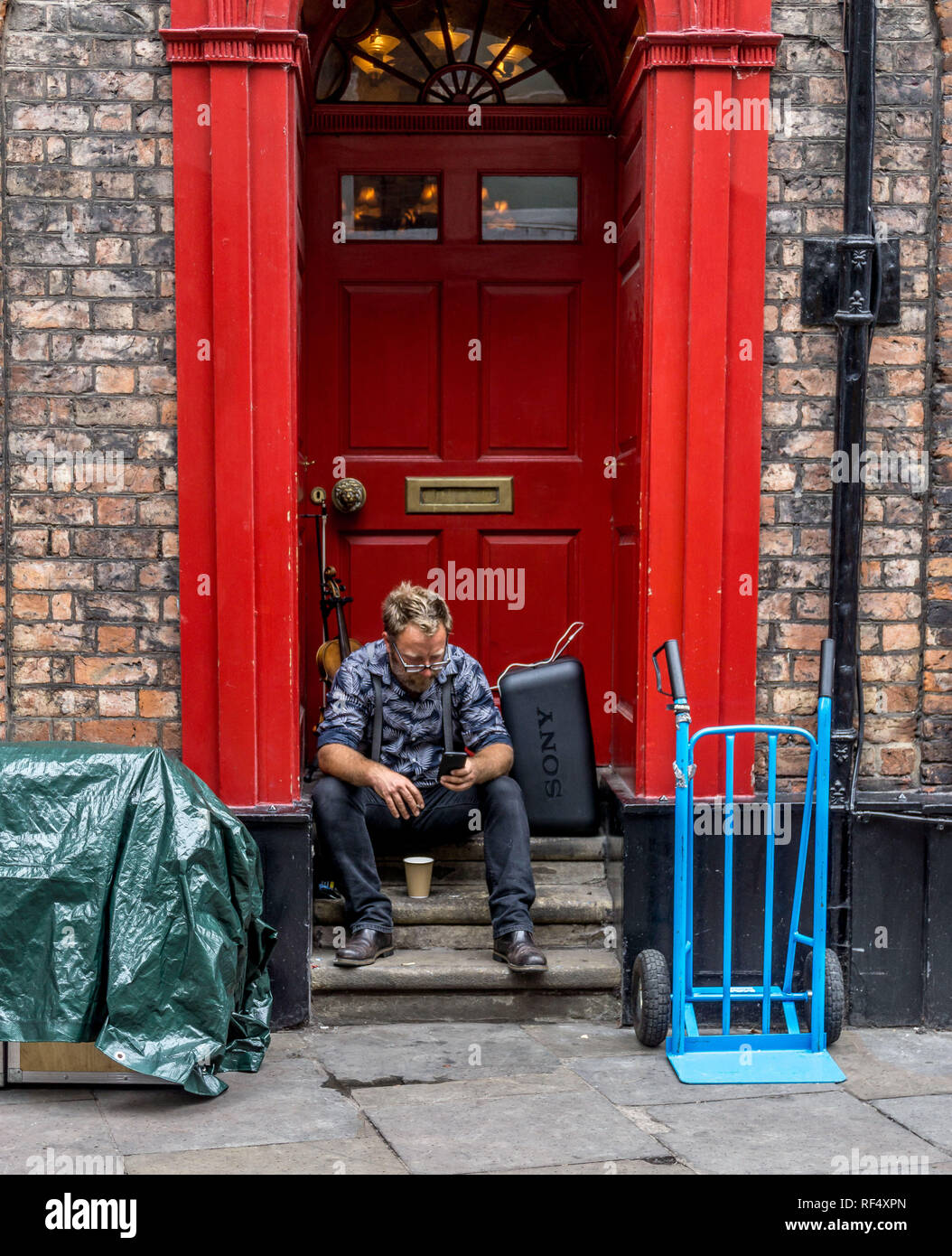male Street musician taking a rest, Shambles, York, North Yorkshire ...