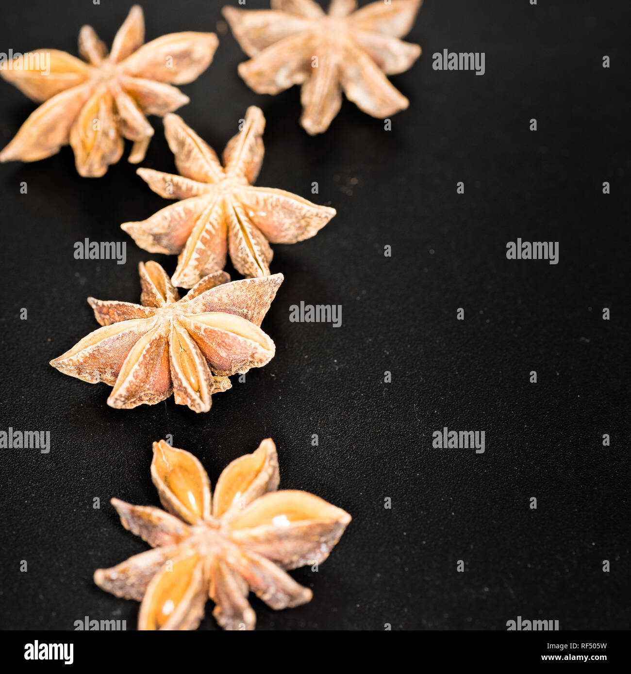 Asian spices, Star anise spice fruits and seeds isolated on black ...