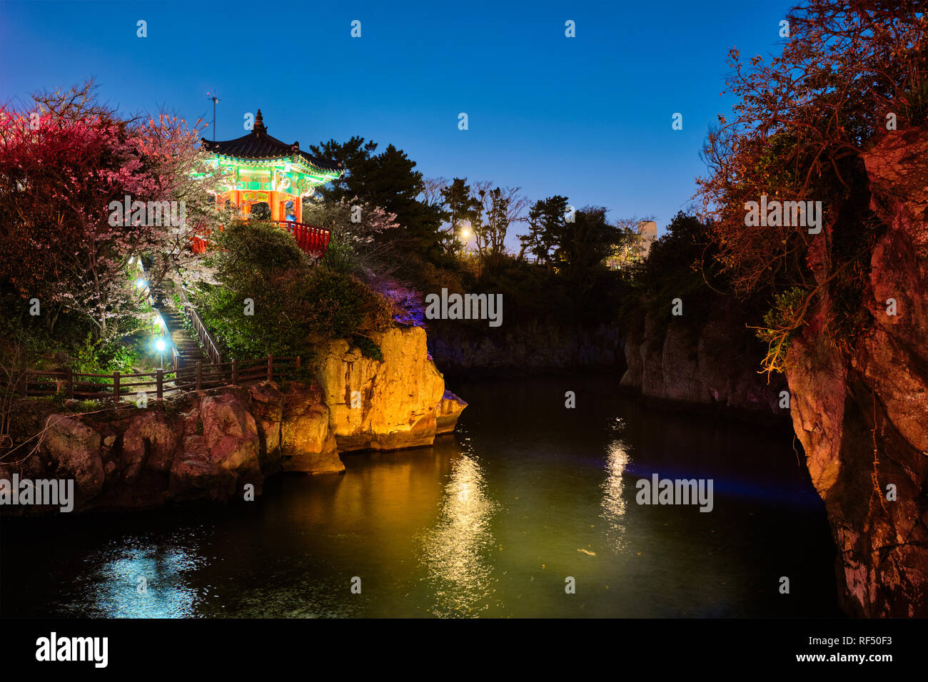Scenic Yongyeon Pond with Yongyeon Pavilion illuminated at night, Jeju islands, South Korea ...