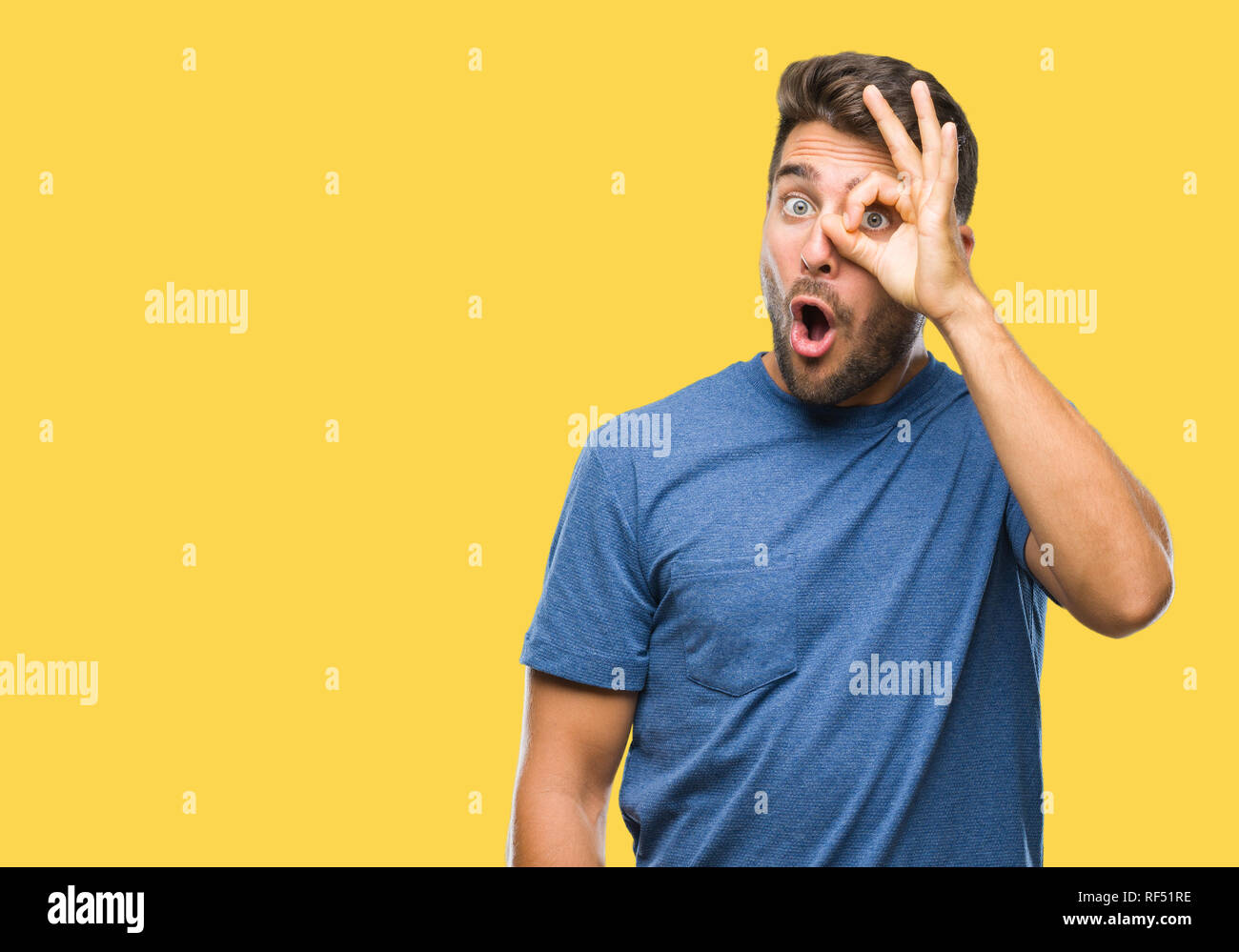 Young handsome man over isolated background doing ok gesture shocked ...
