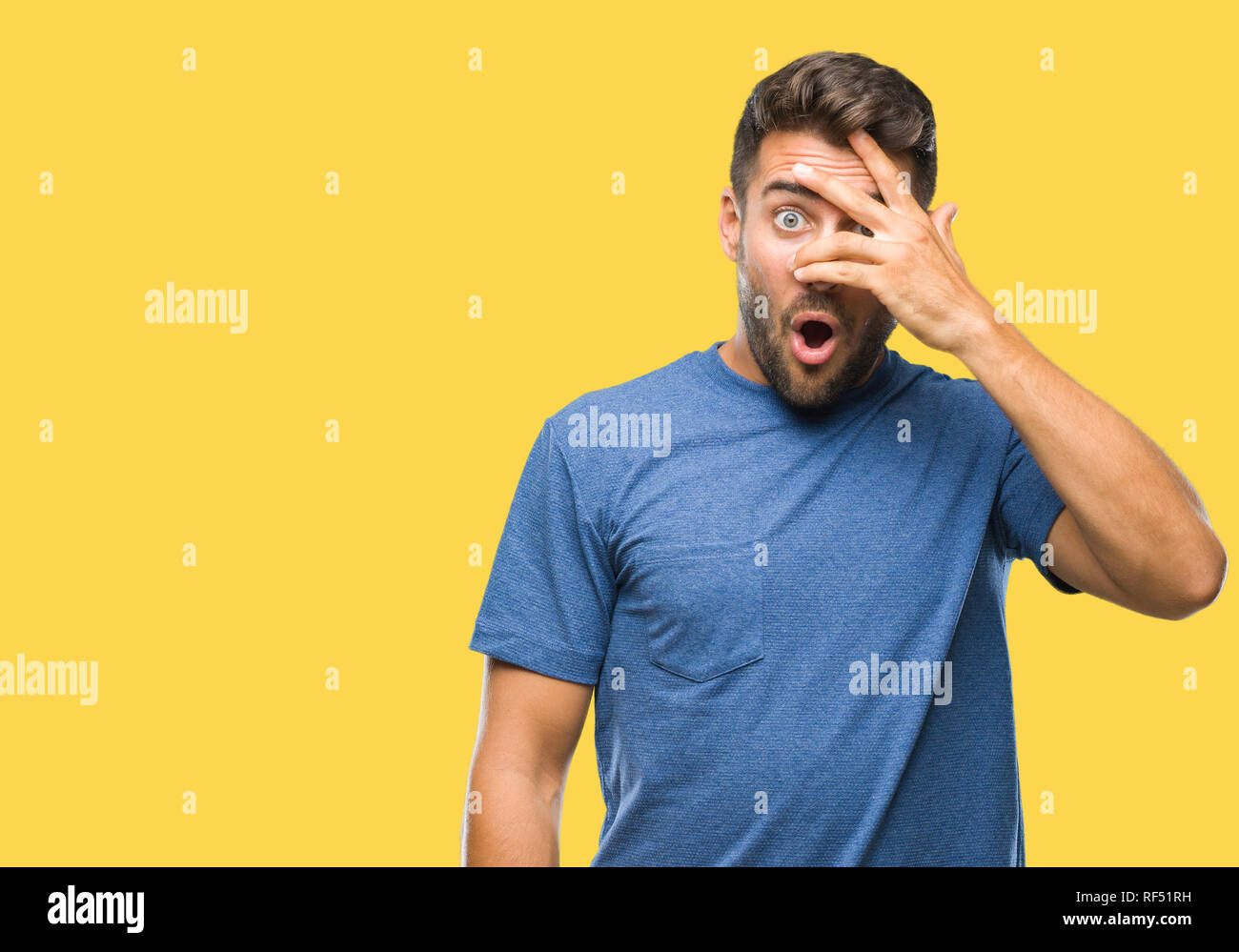 Young handsome man over isolated background peeking in shock covering ...