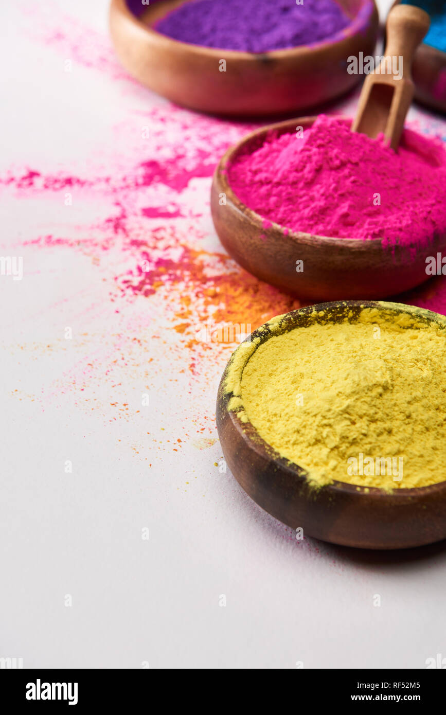 wooden bowls with pink and yellow holi powder on white background Stock ...