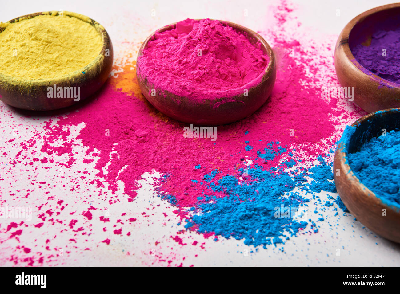 wooden bowls with multicolored holi powder on white background Stock ...