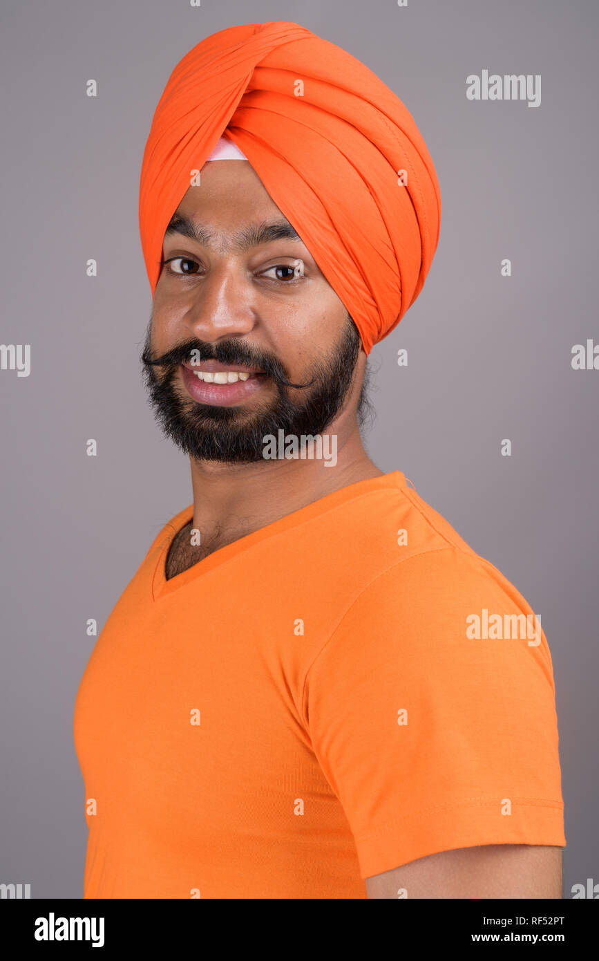 Indian Sikh man wearing turban and orange shirt Stock Photo - Alamy