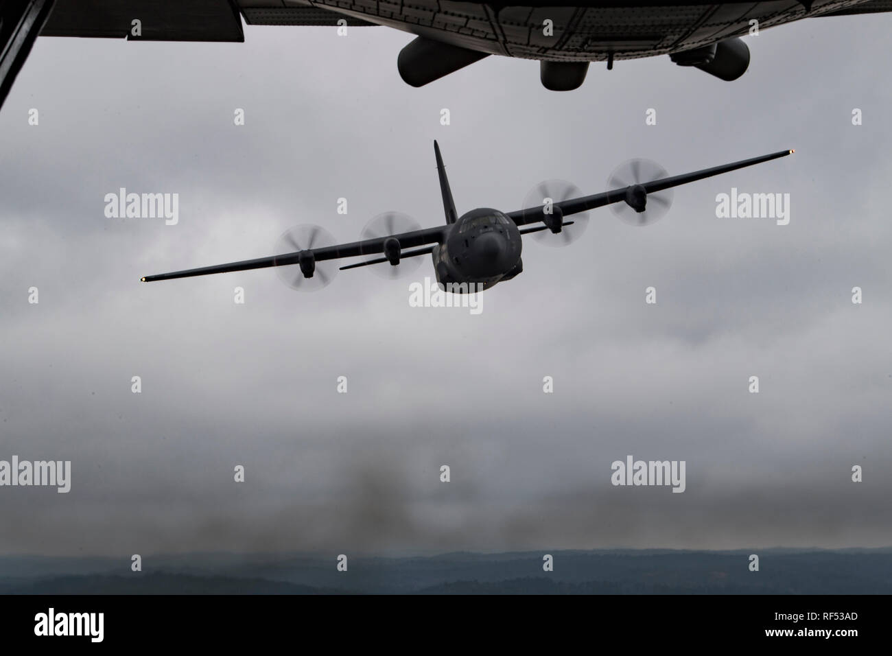 A Royal Danish Air Force C-130J Hercules flies in formation with a U.S ...