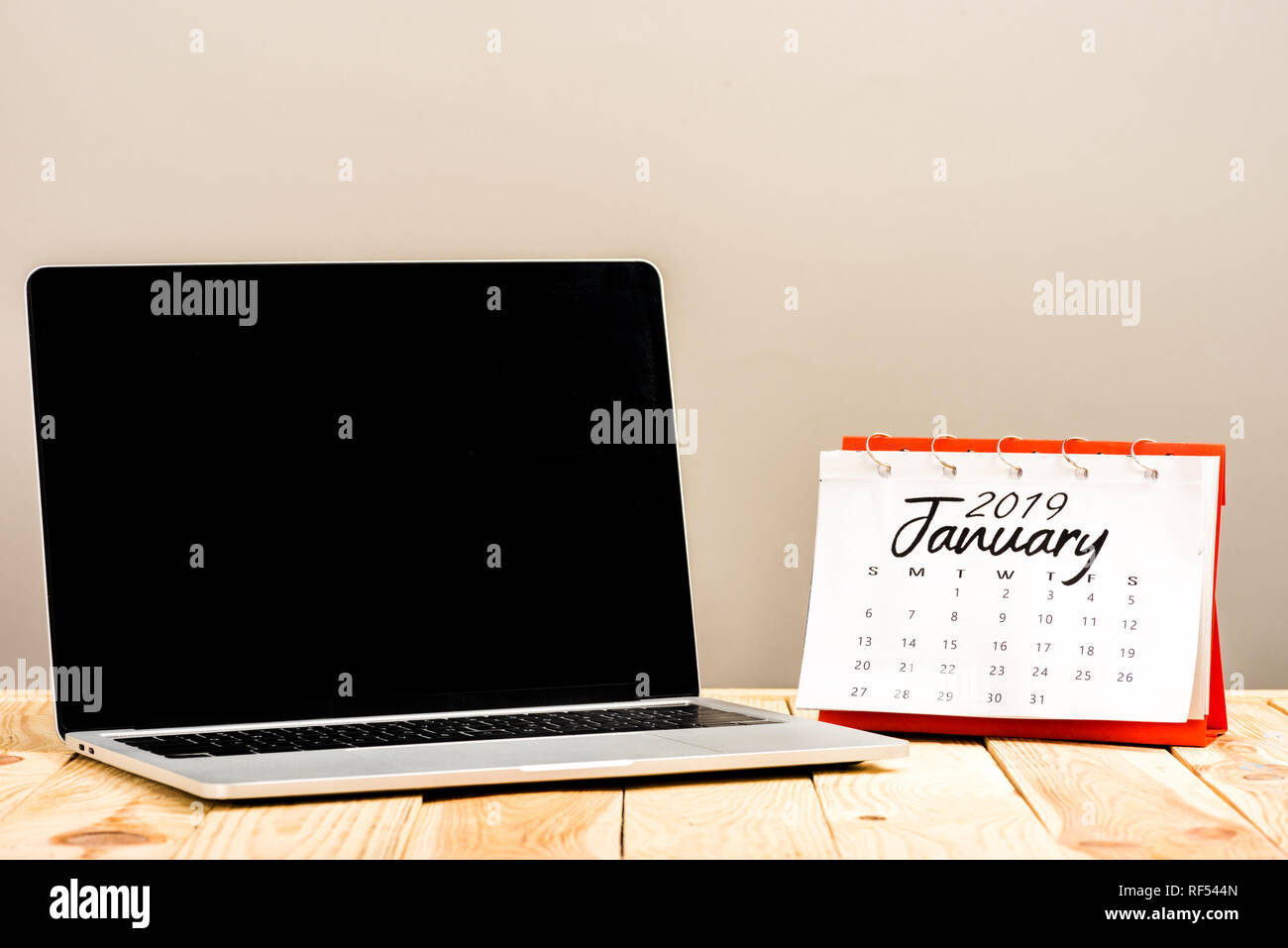 calendar with 'january 2019' lettering and laptop with blank screen ...