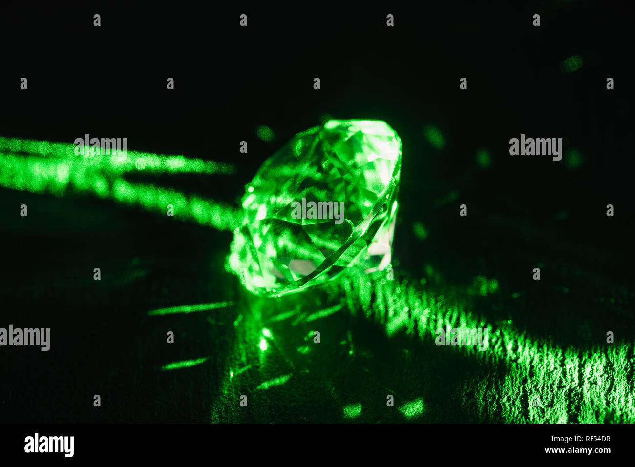 pure diamond with bright green neon ray on dark background Stock Photo ...