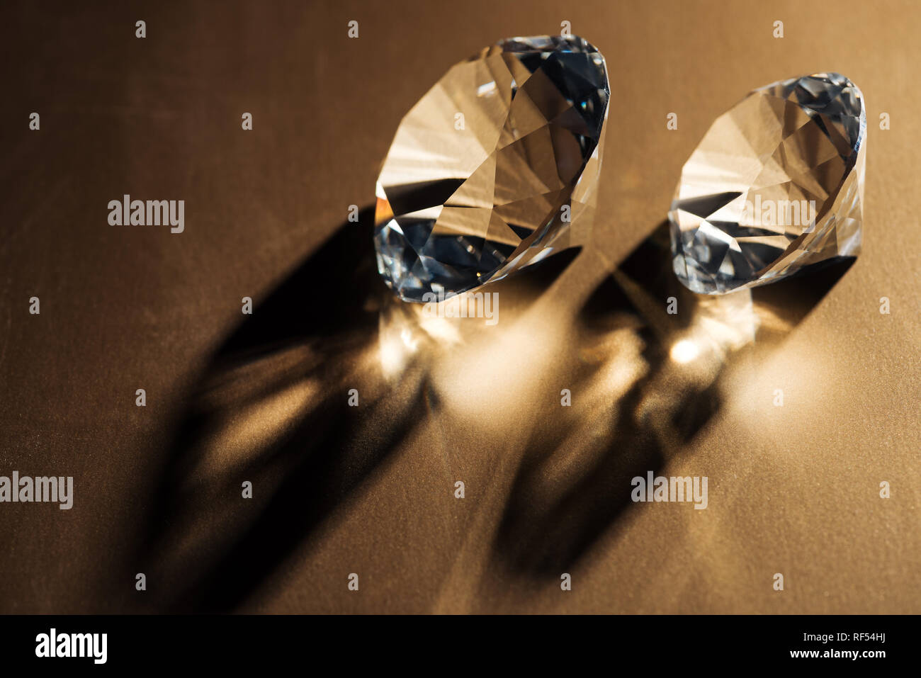 sparkling clear diamonds on brown background reflecting light Stock ...