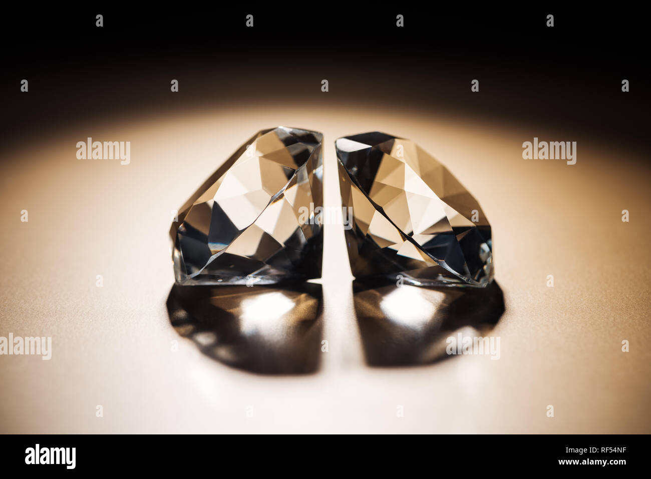 two clear big diamonds on black and golden background Stock Photo - Alamy