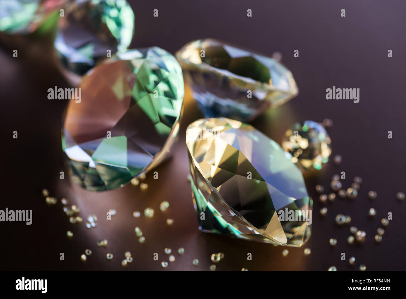 collection of shiny clear diamonds on brown background Stock Photo - Alamy