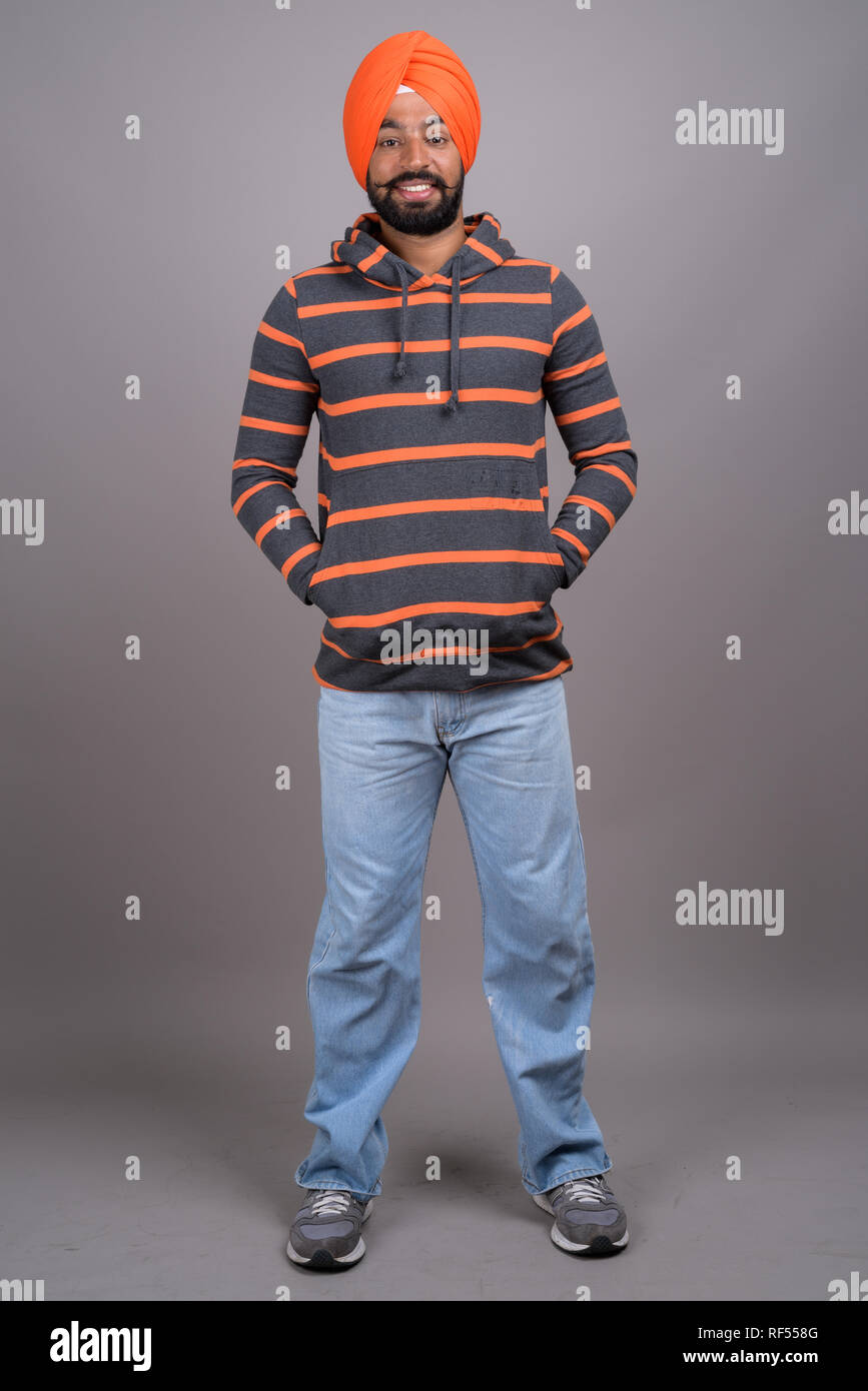 Full length shot of young handsome Indian Sikh man with turban Stock ...