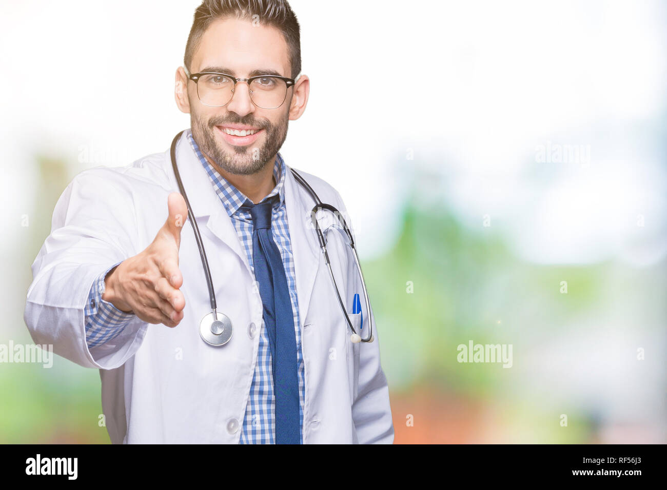 Handsome young doctor man over isolated background smiling friendly ...