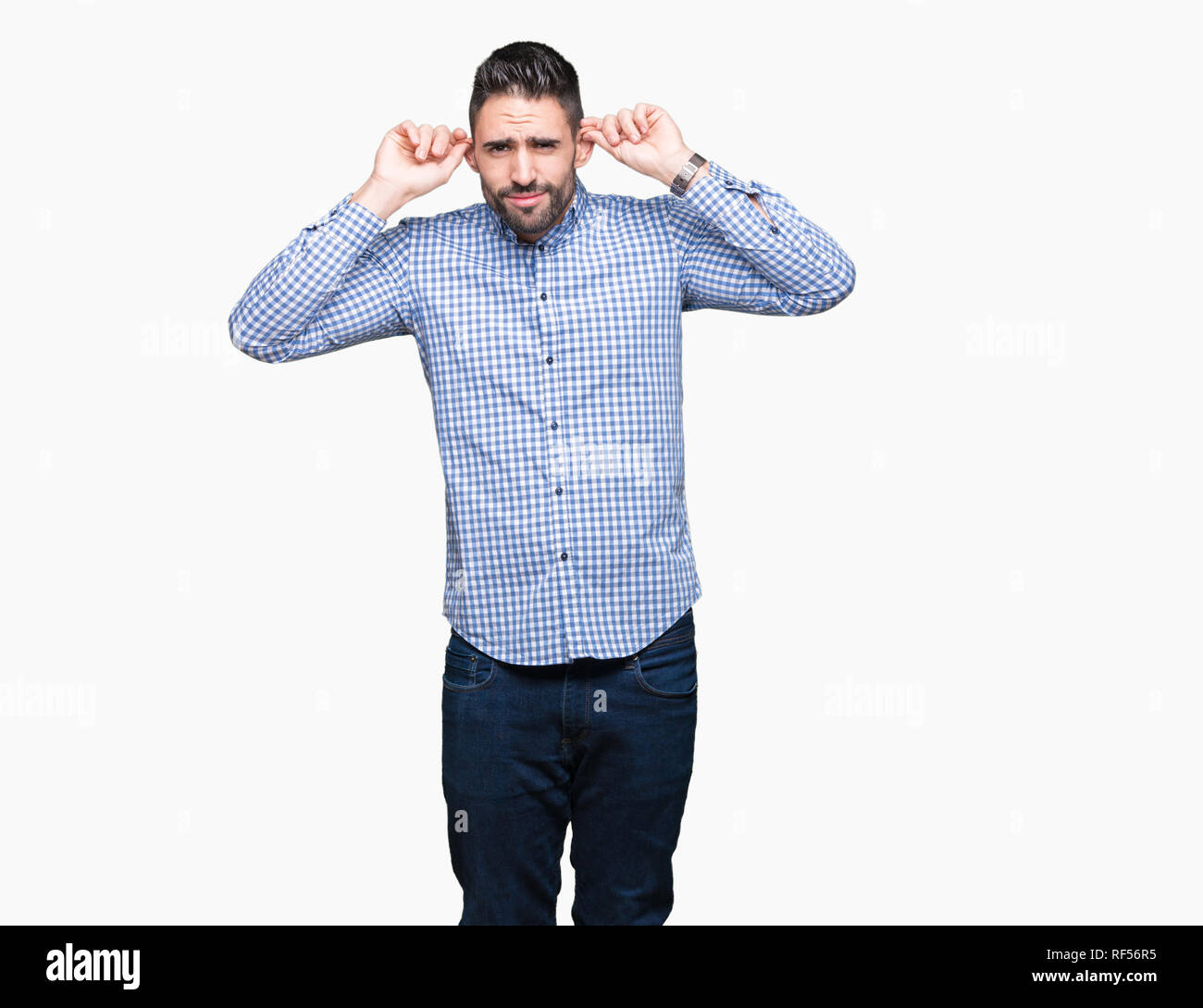Young handsome man over isolated background Smiling pulling ears with ...