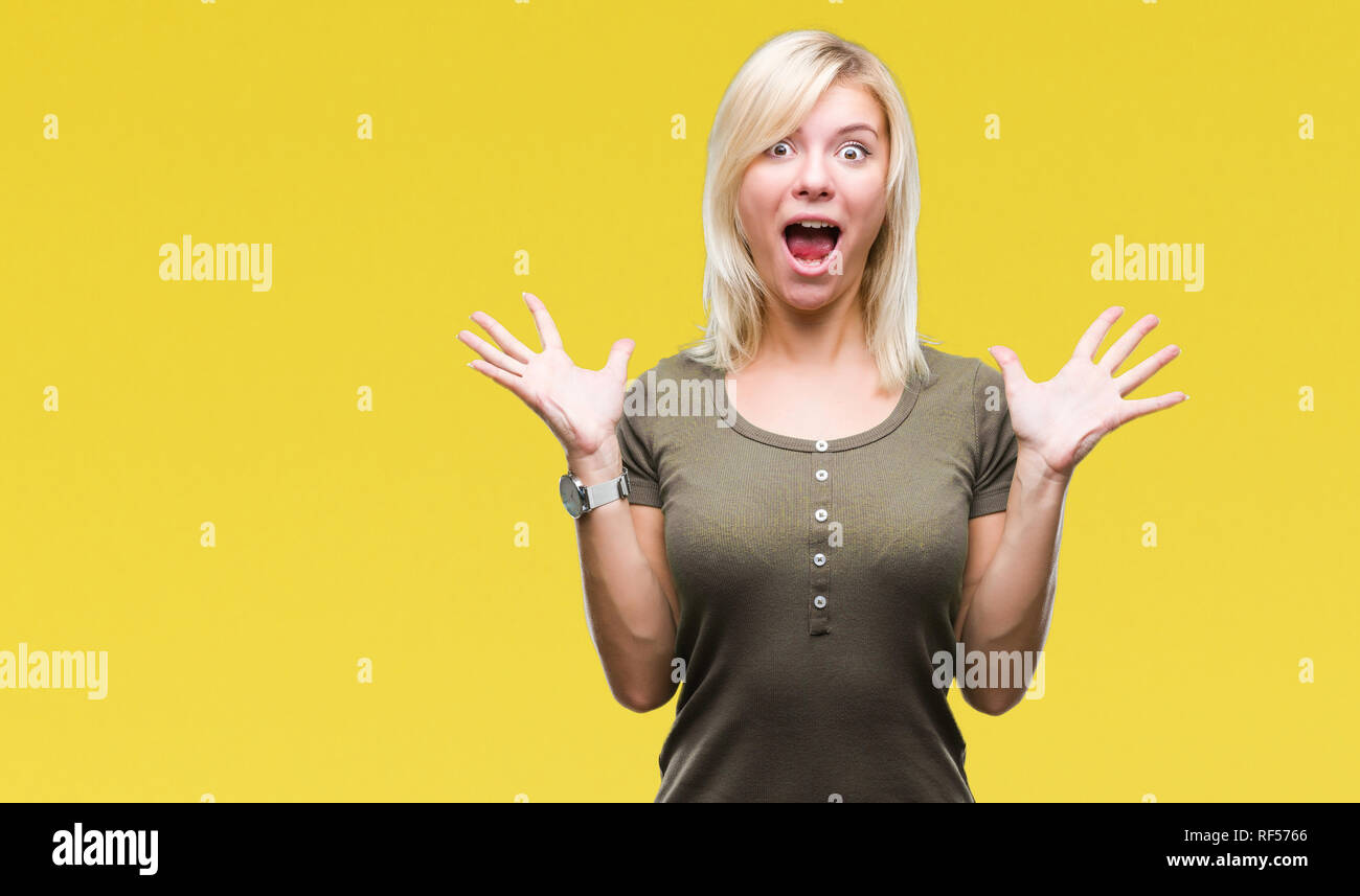 Young beautiful blonde woman over isolated background celebrating crazy ...