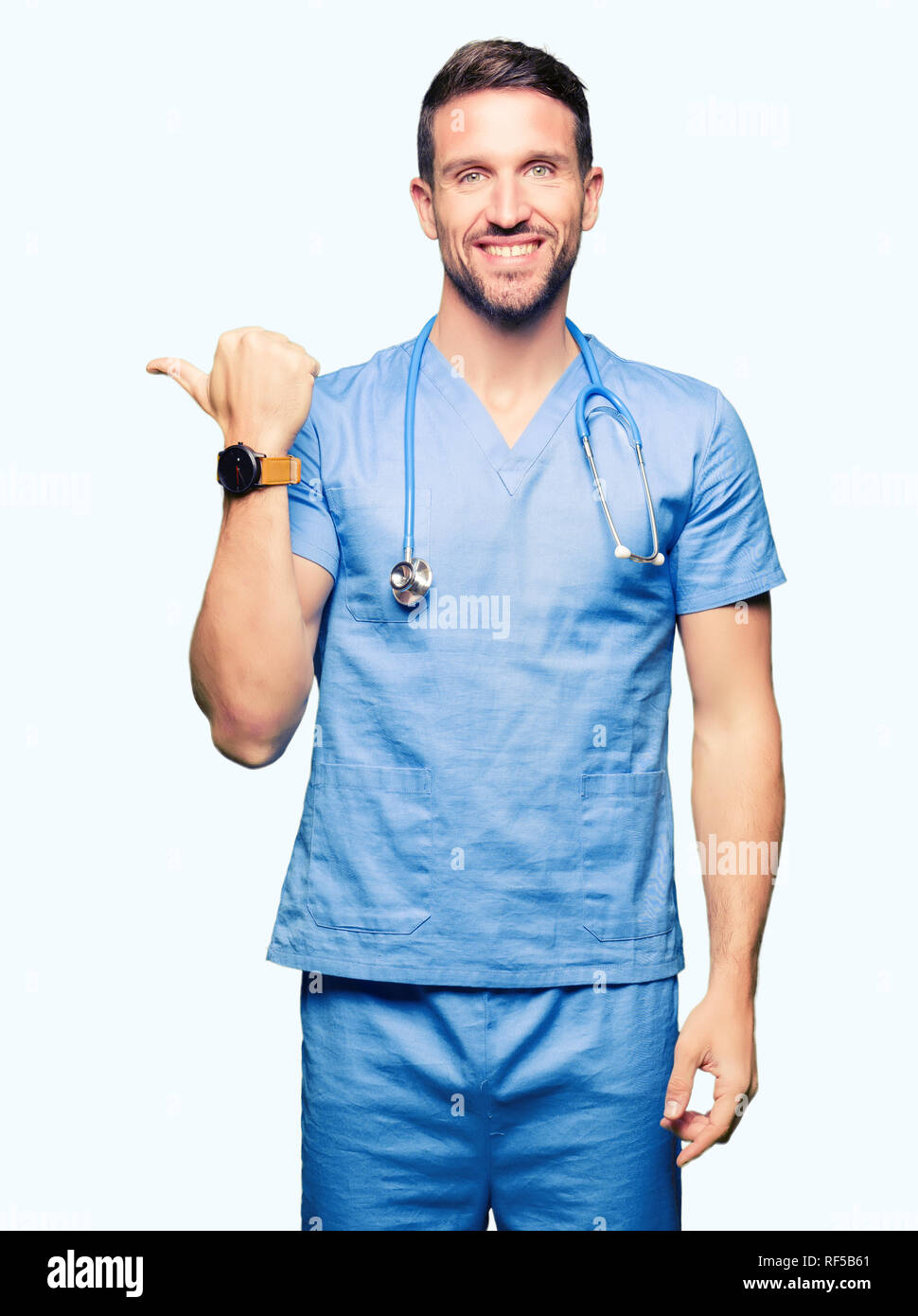 Handsome doctor man wearing medical uniform over isolated background ...
