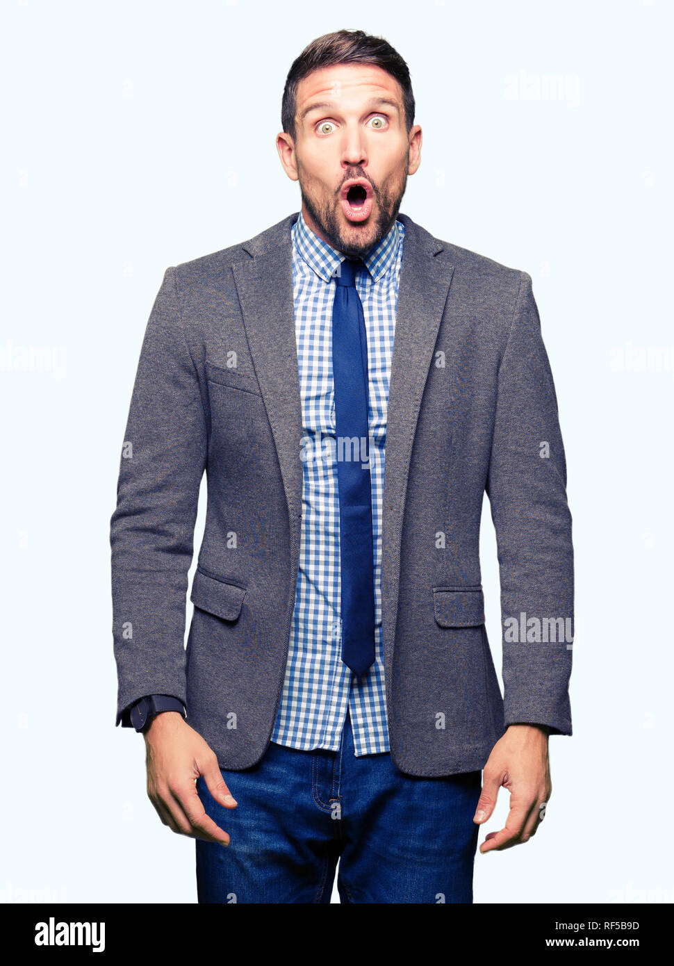 Handsome business man wearing suit and tie afraid and shocked with ...